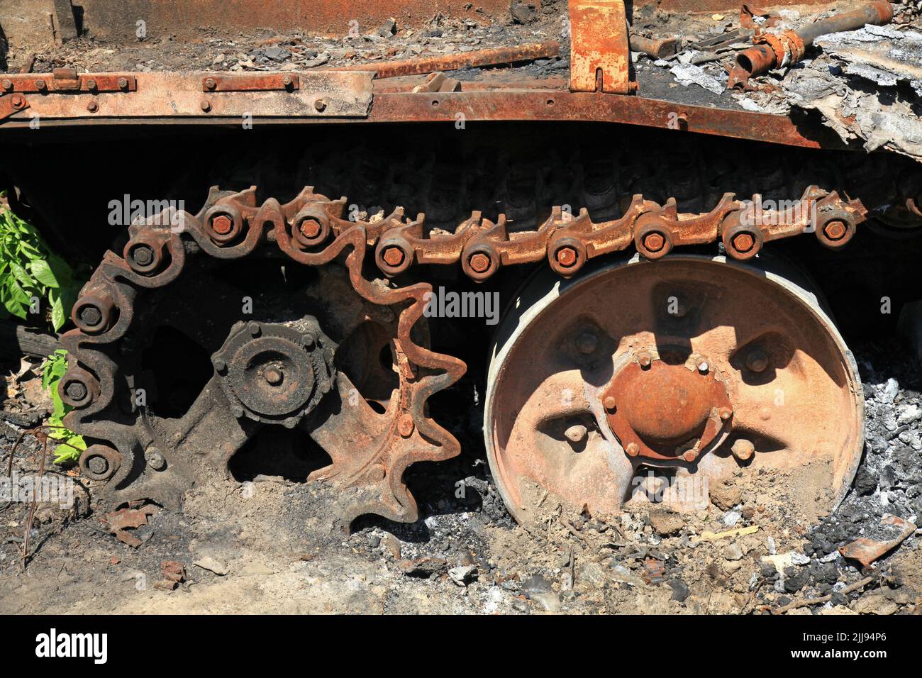 A fragment of a caterpillar of a burnt and charred tank. A blown up and ...