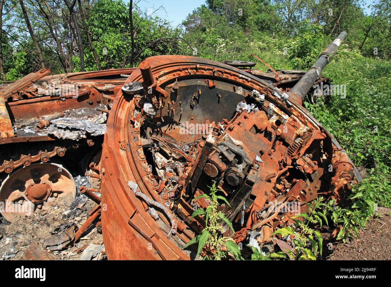 Torn off turret of a burnt and charred tank close-up. A blown up and ...