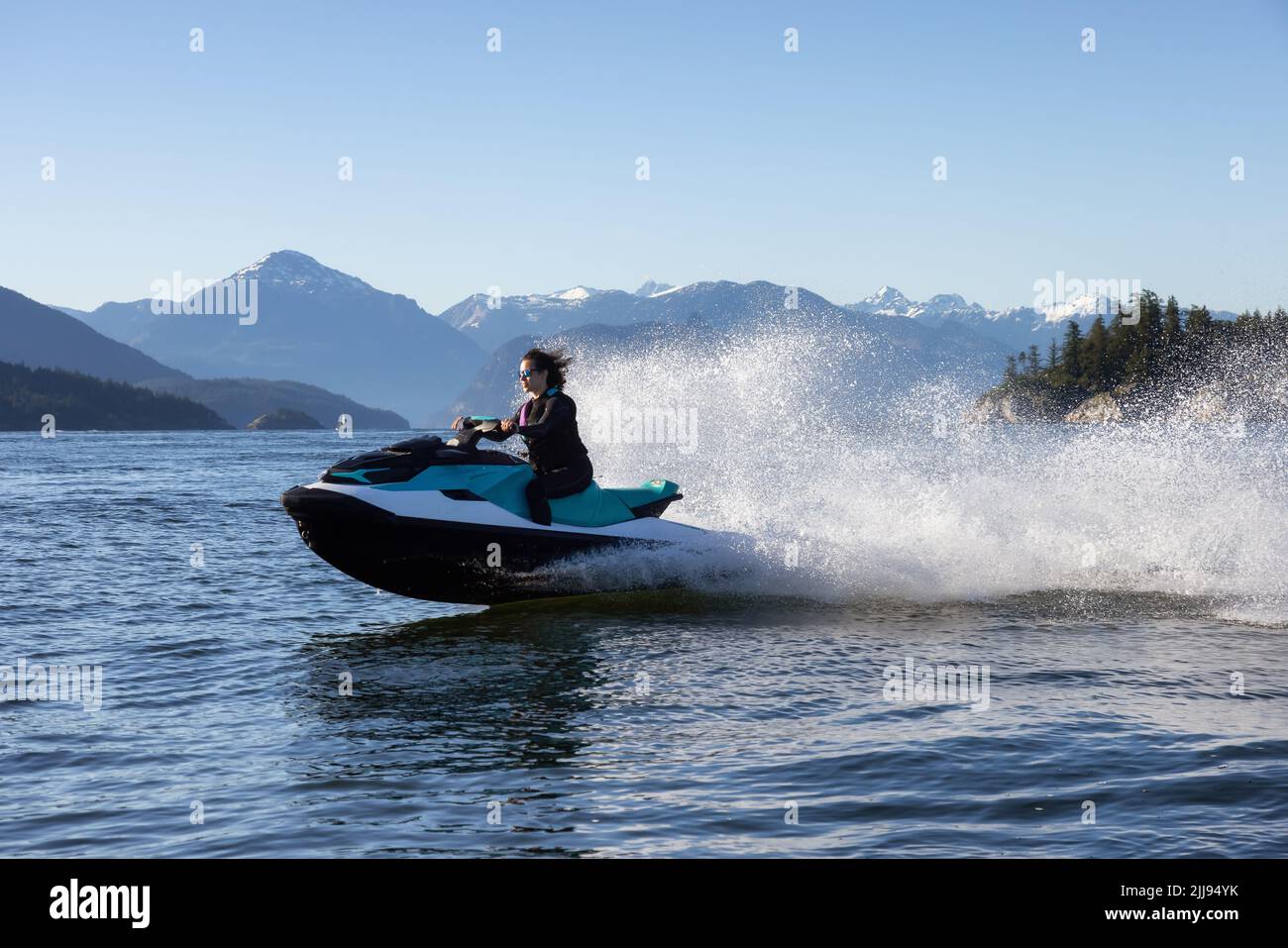 Adventurous Caucasian Woman on Sea-Doo riding in the Ocean Stock Photo ...