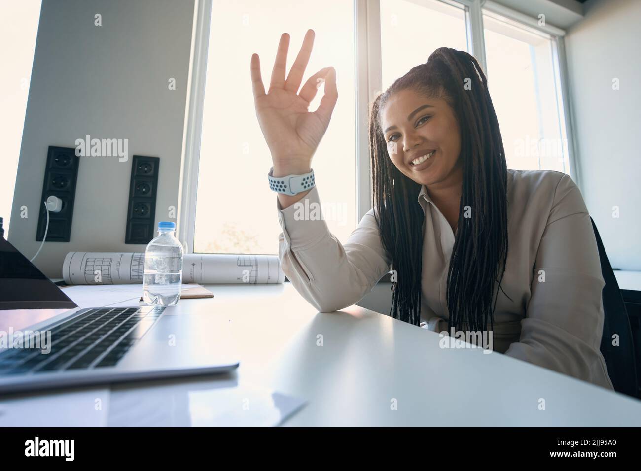 Residential design professional posing for camera seated at window desk ...