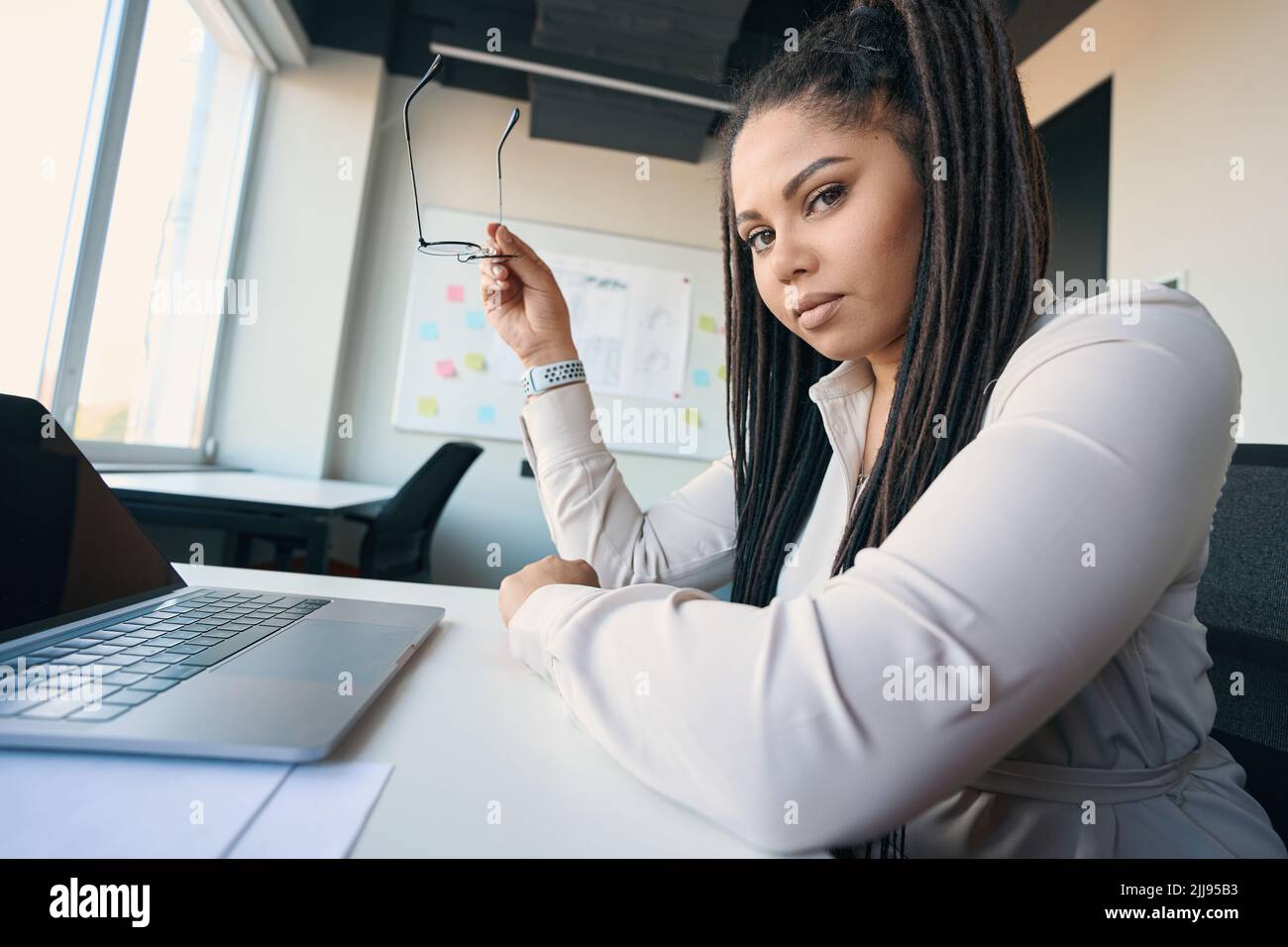 Female office worker seated desk hi-res stock photography and images ...