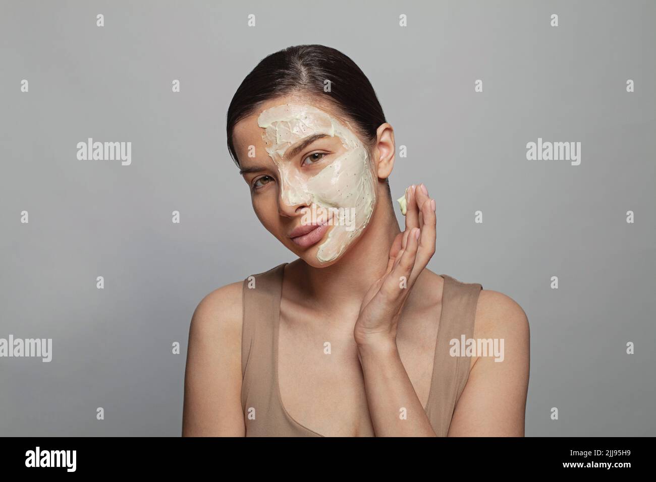 Portrait of perfect spa model woman brunette with cosmetic mask on her ...