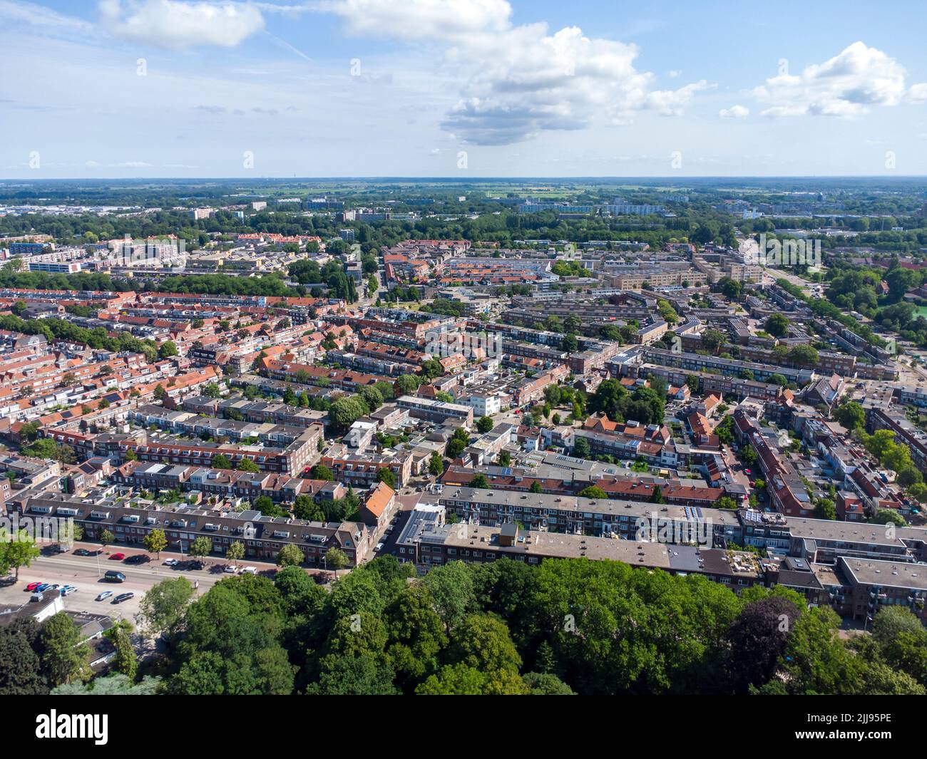 An aerial shot of a compact mid rise city under a blue sky with white ...