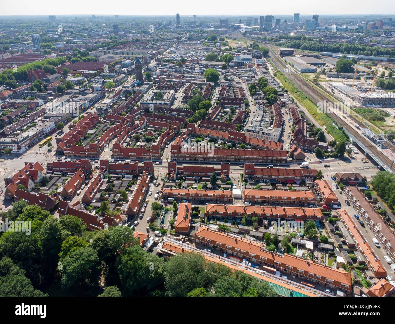 An aerial shot of a compact mid rise city under a blue sky with white ...