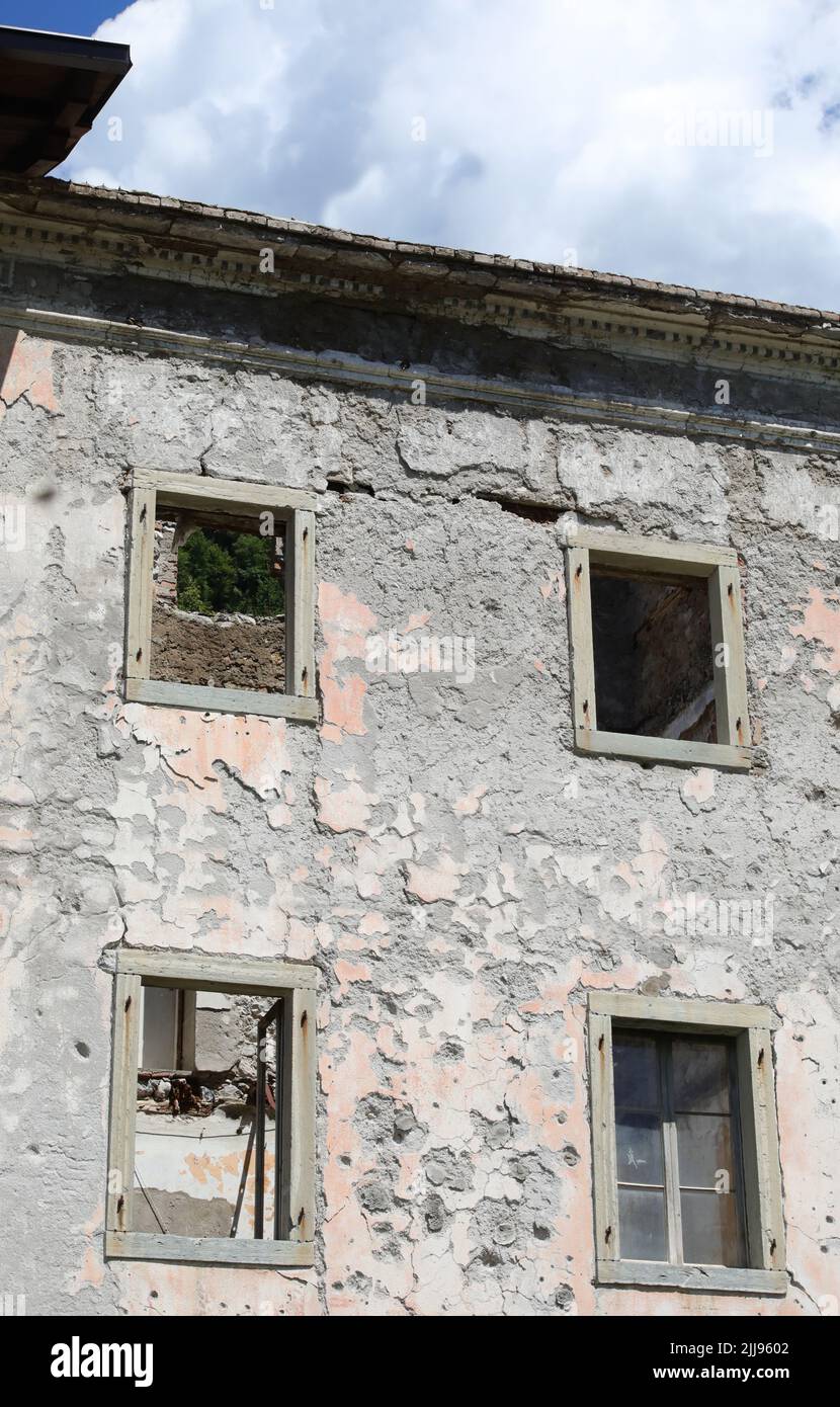 four windows without the frames of a completely destroyed house without ...