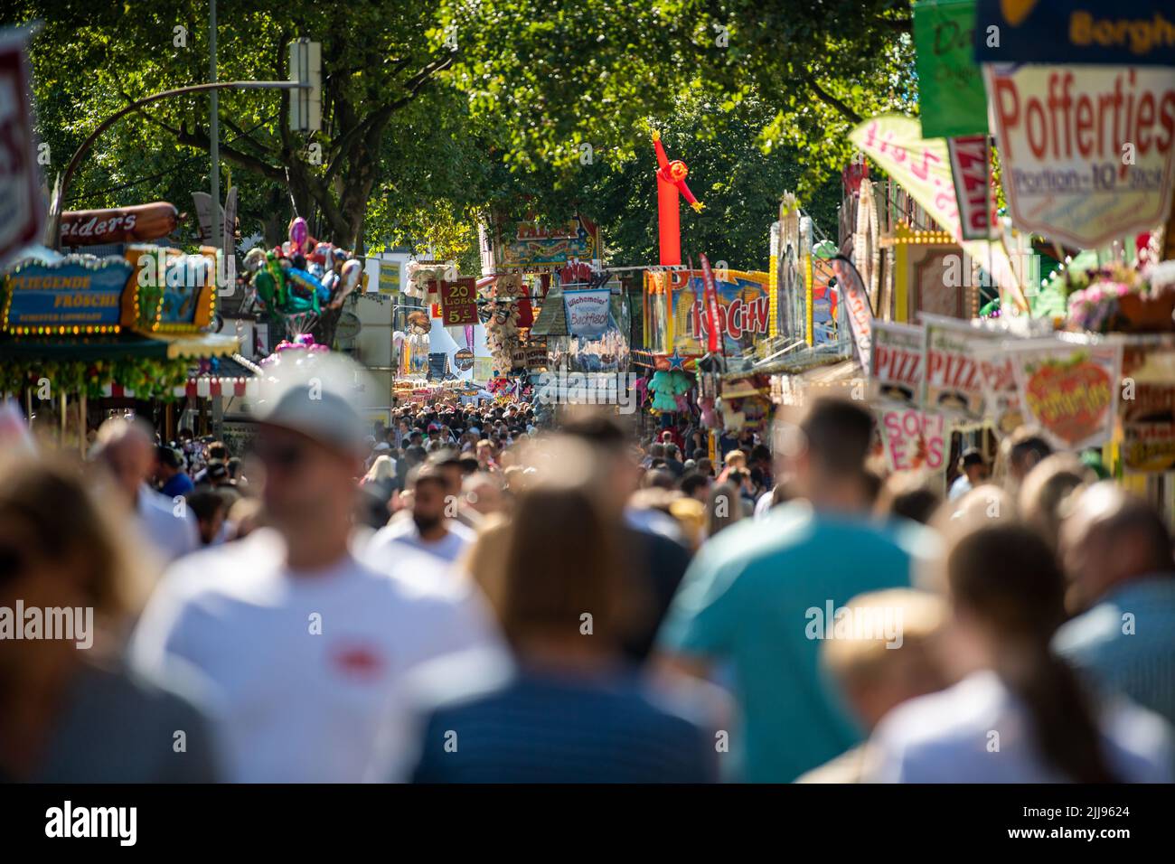 Paderborn, Germany. 24th July, 2022. Visitors cavort between funfair ...
