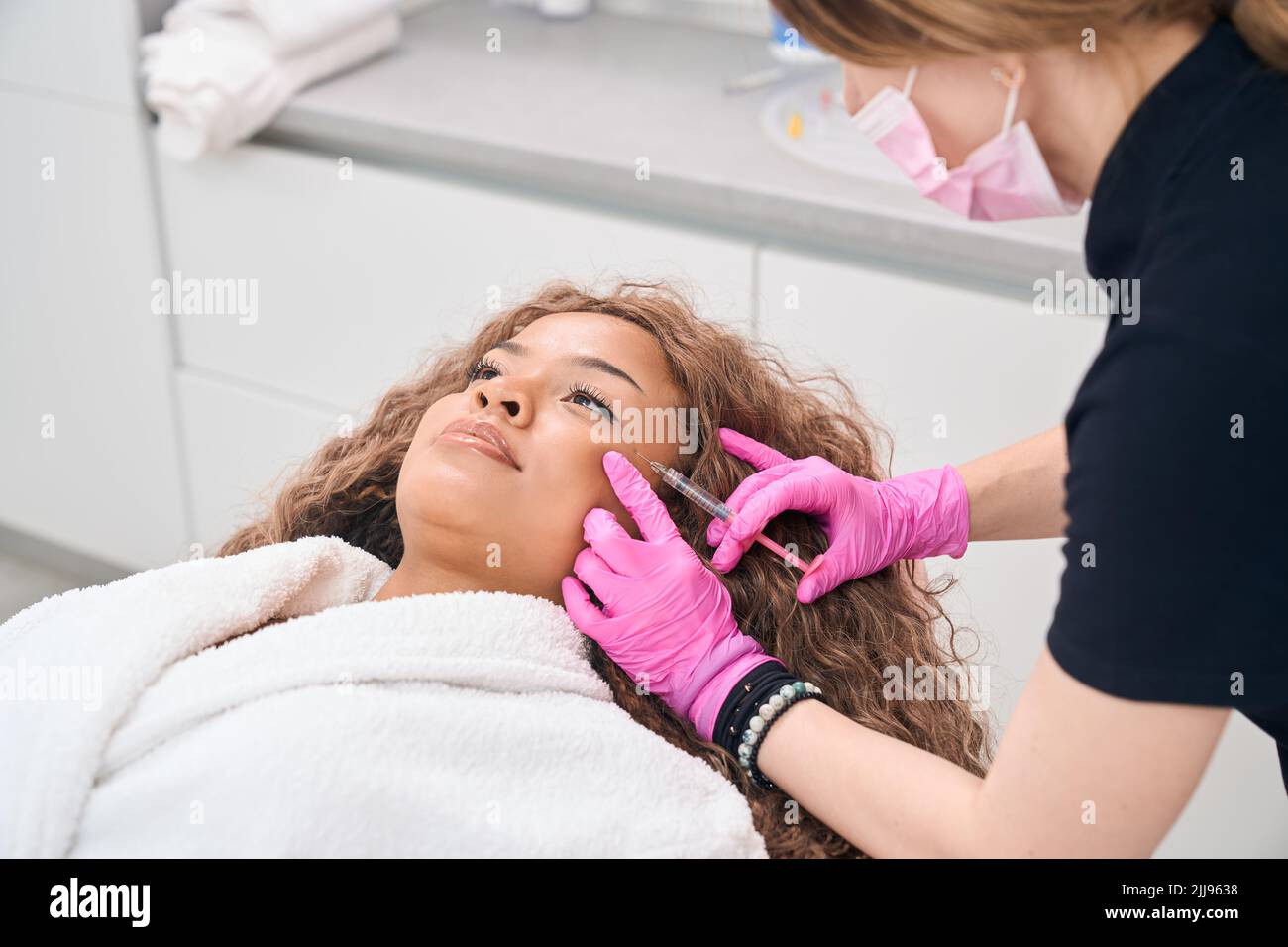 Woman receives botulinum toxin injections in clinic of aesthetic ...