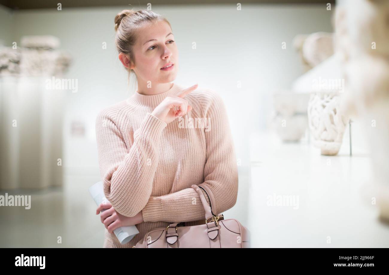 Woman with guide-book in museum of antique sculptures Stock Photo - Alamy