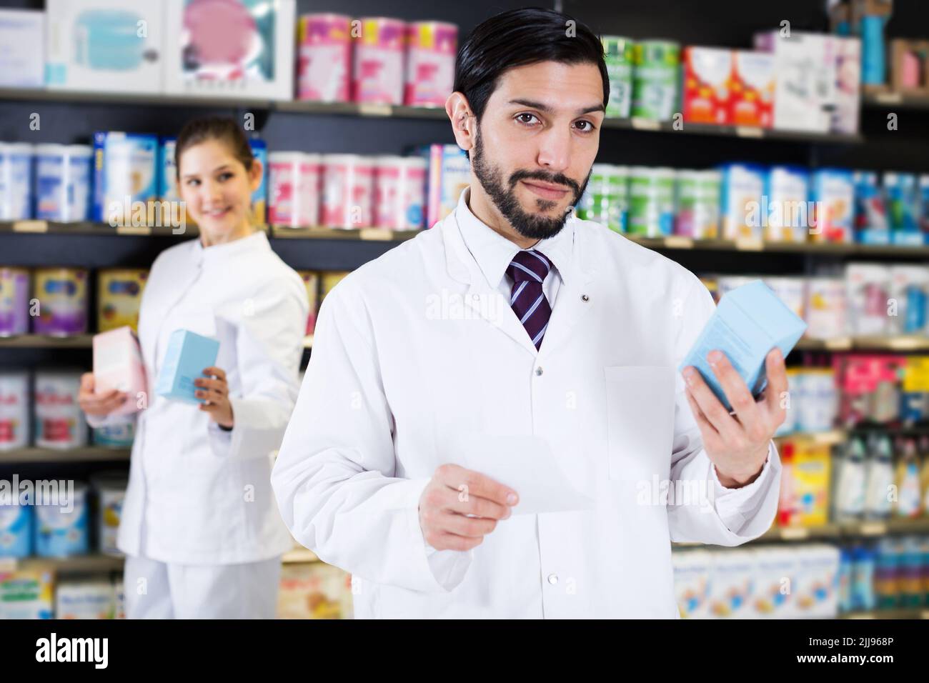 pharmacist standing with medicine on his work place Stock Photo - Alamy