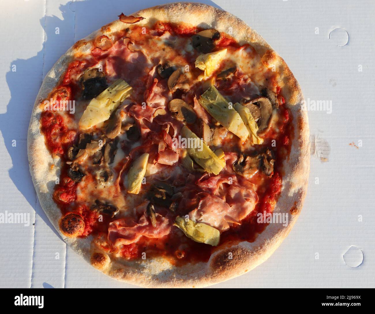 pizza called in Italy of the capricciosa with mushrooms ham artichokes ...