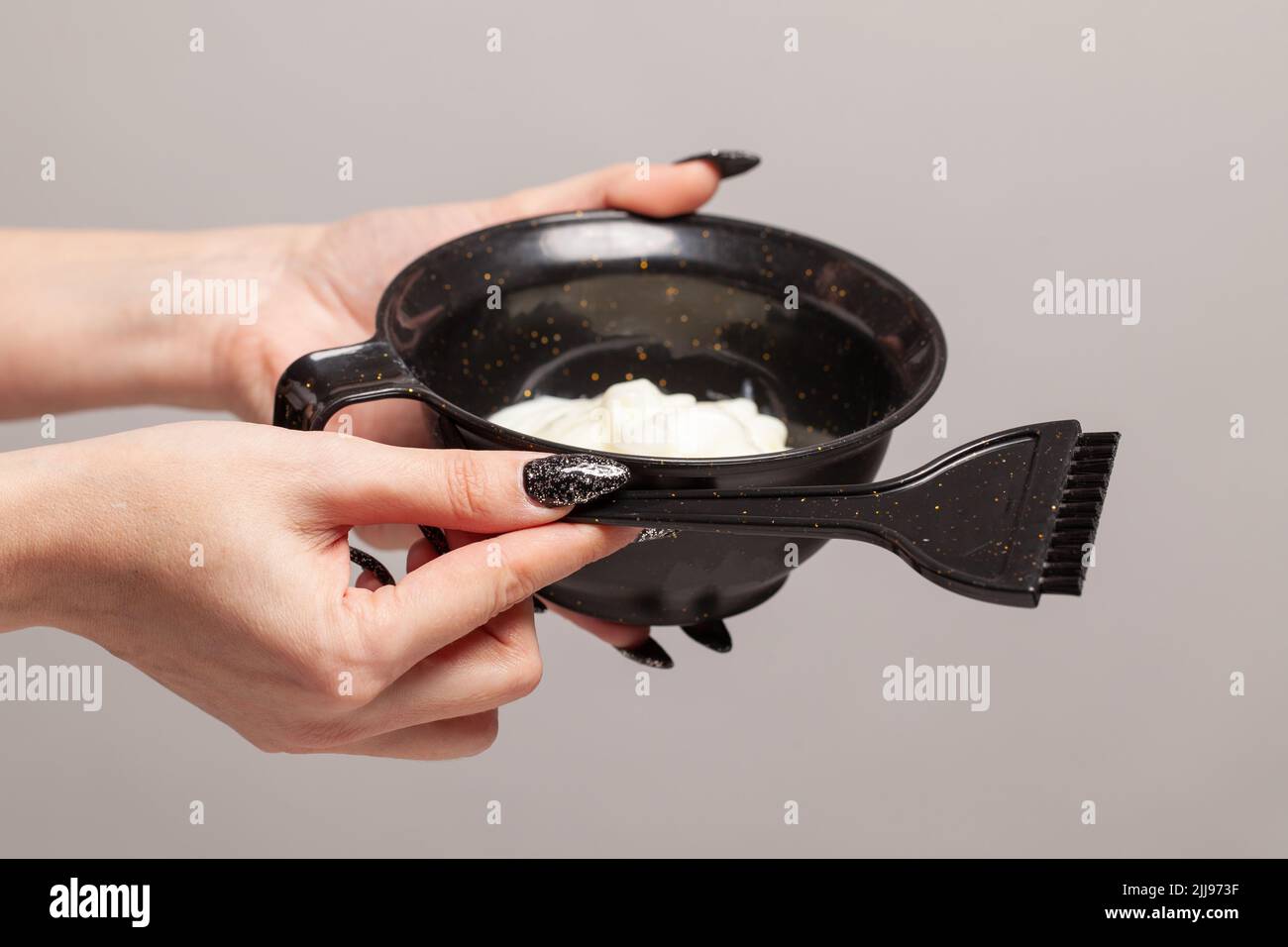 Woman preparing dye for hair coloring on white background Stock Photo ...
