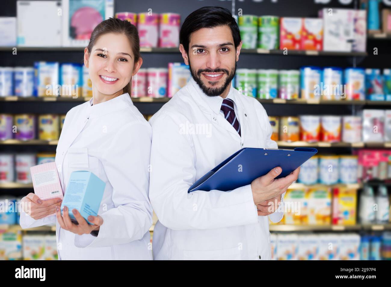 pharmacist and expert standing near shelves with medicines Stock Photo ...