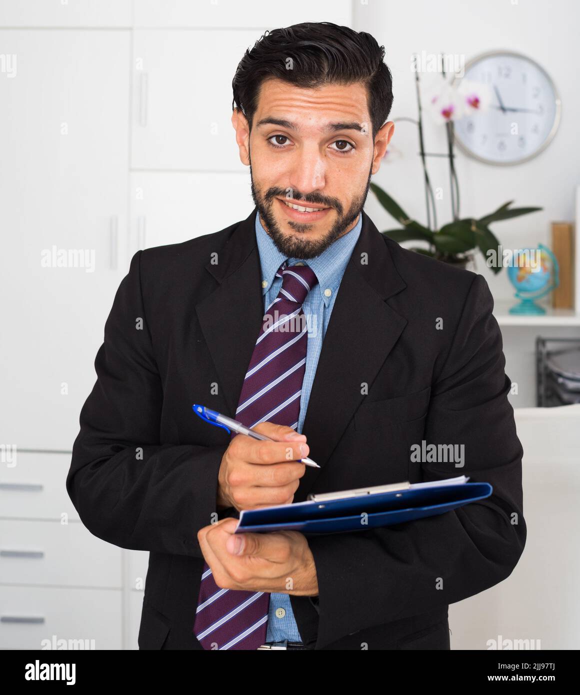 Adult male is signing financical papers Stock Photo - Alamy