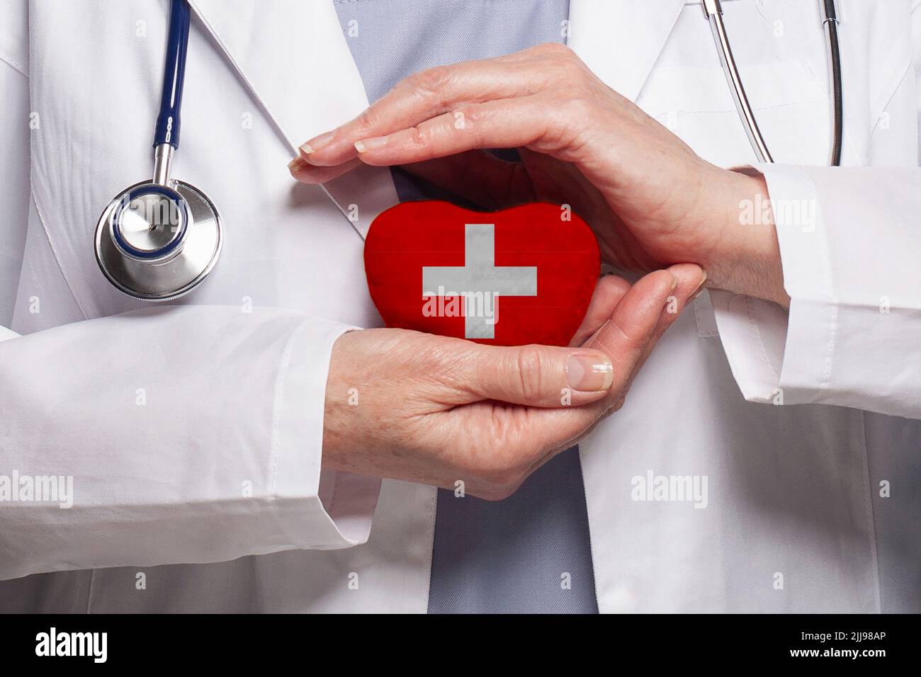 Swiss doctor holding heart with flag of Switzerland background ...