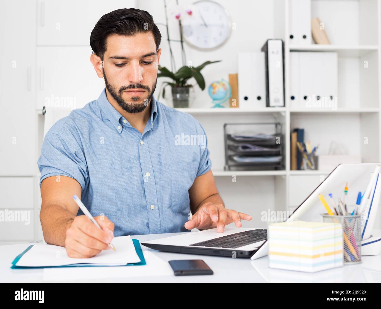 Young manager reading documents hi-res stock photography and images - Alamy