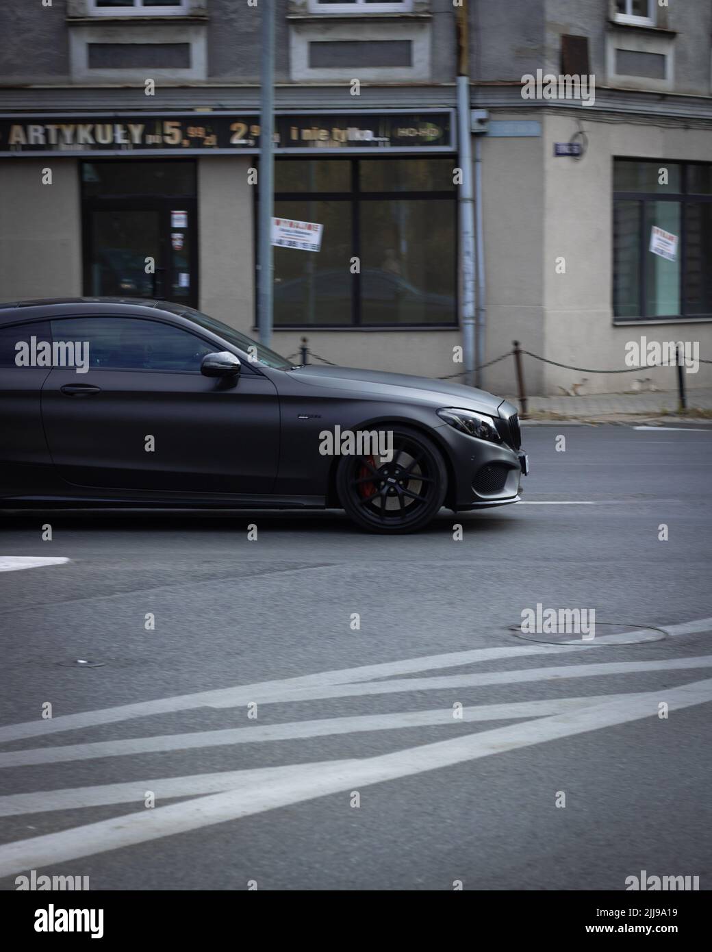 A vertical shot of a Mercedes Benz C Class AMG on the road Stock Photo ...