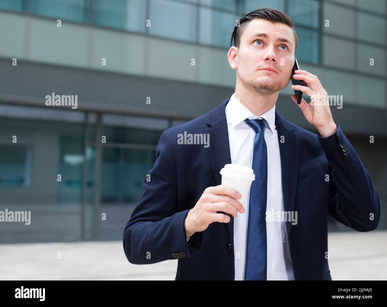 Talking on phone man drinking hi-res stock photography and images - Alamy