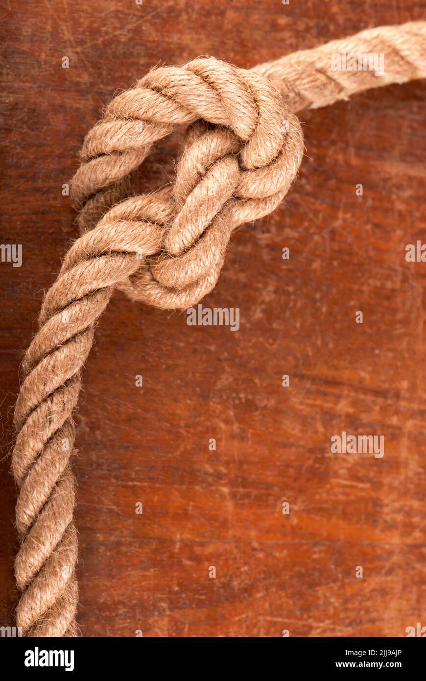 Rope with Reef Knot on Wood Texture Stock Photo - Alamy