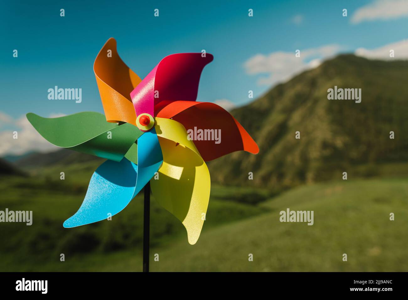 Symbol of clean green energy, Close-up multi-colored pinwheel ...