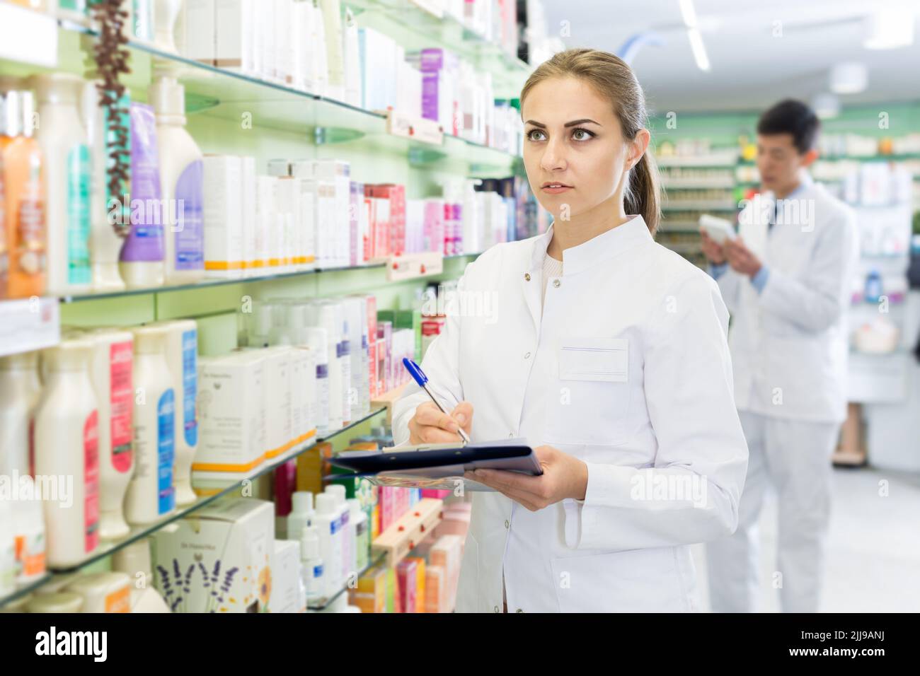 Female pharmacist checking medication hi-res stock photography and ...