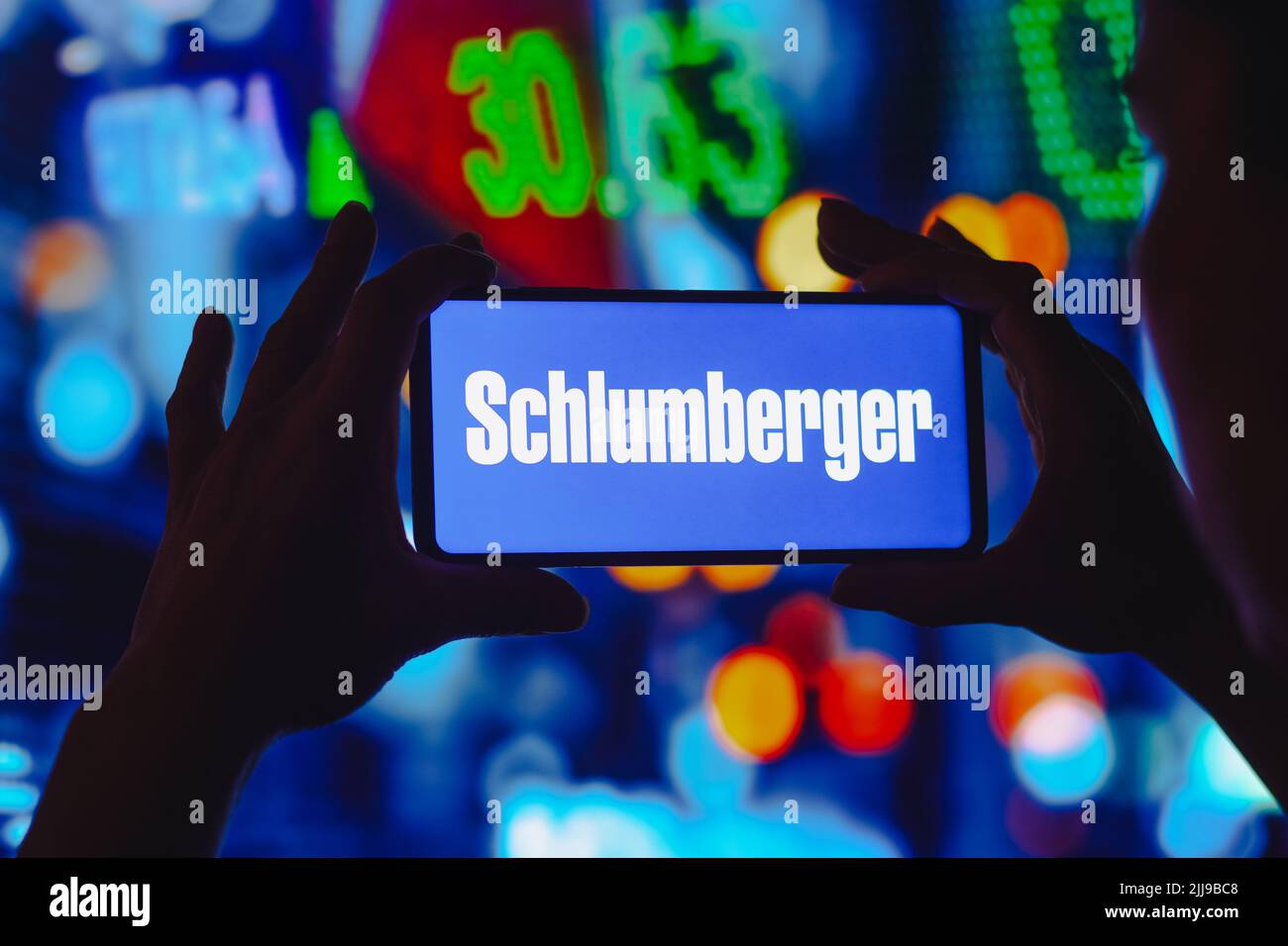In this photo illustration, the Schlumberger logo is displayed on a ...