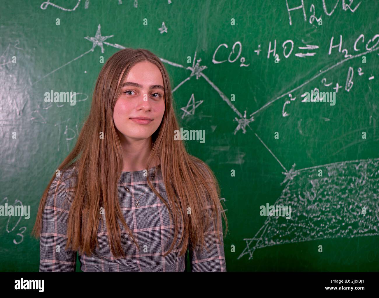 Student girl standing near clean blackboard in the classroom Stock ...