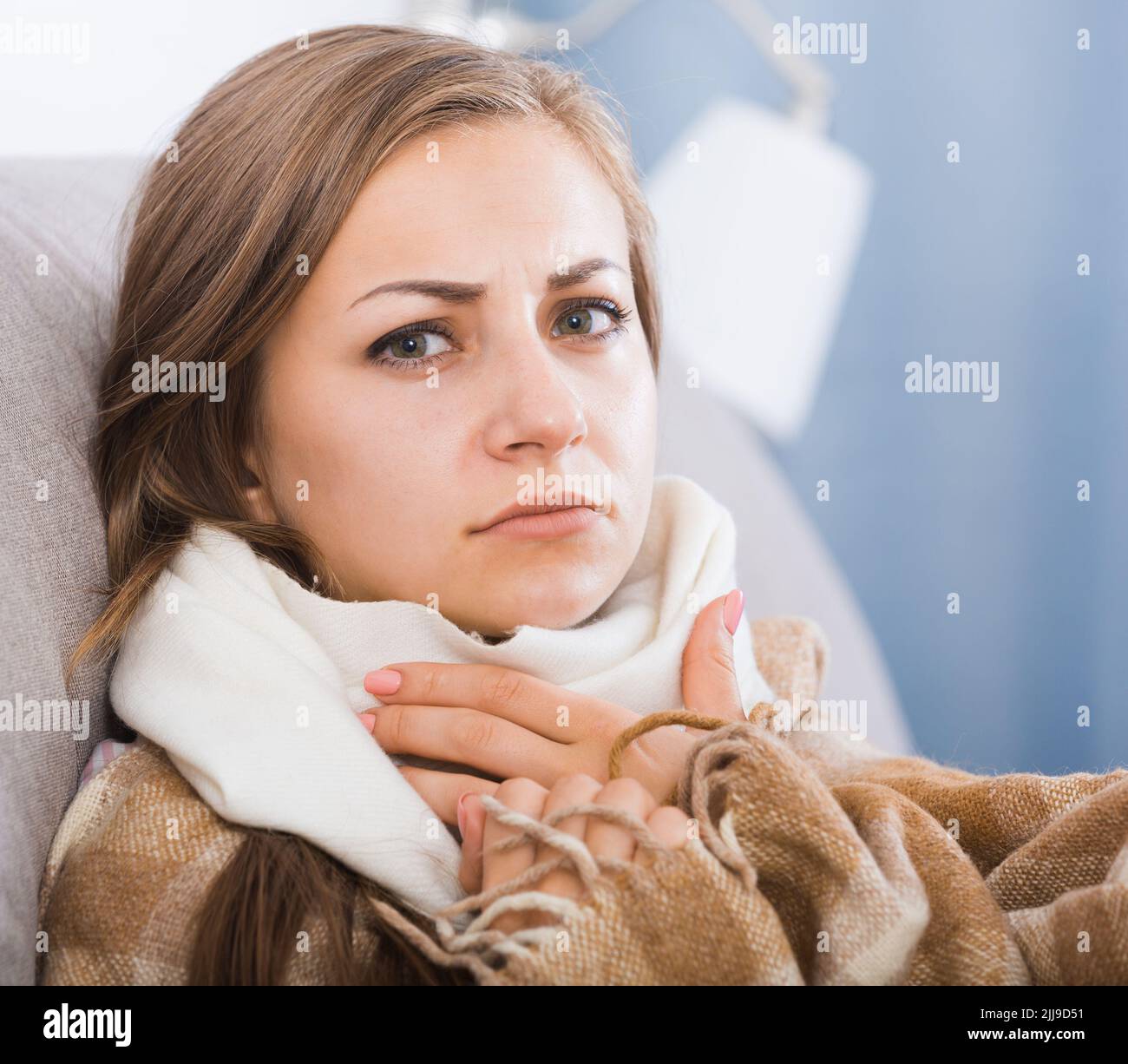 Sick girl with scarf on neck Stock Photo - Alamy