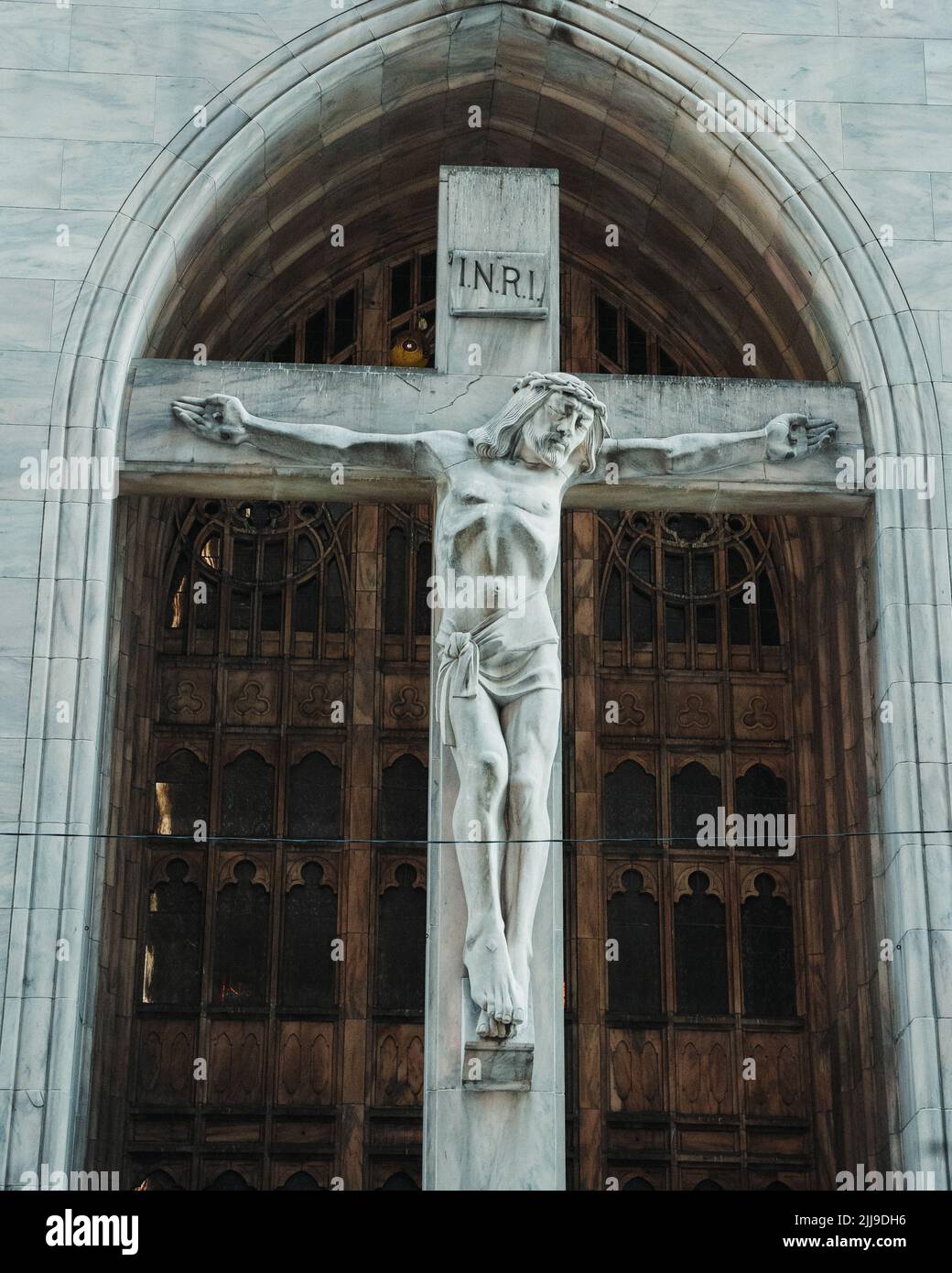 A vertical shot of a sculpture of Jesus Christ on the cross in St Peter ...
