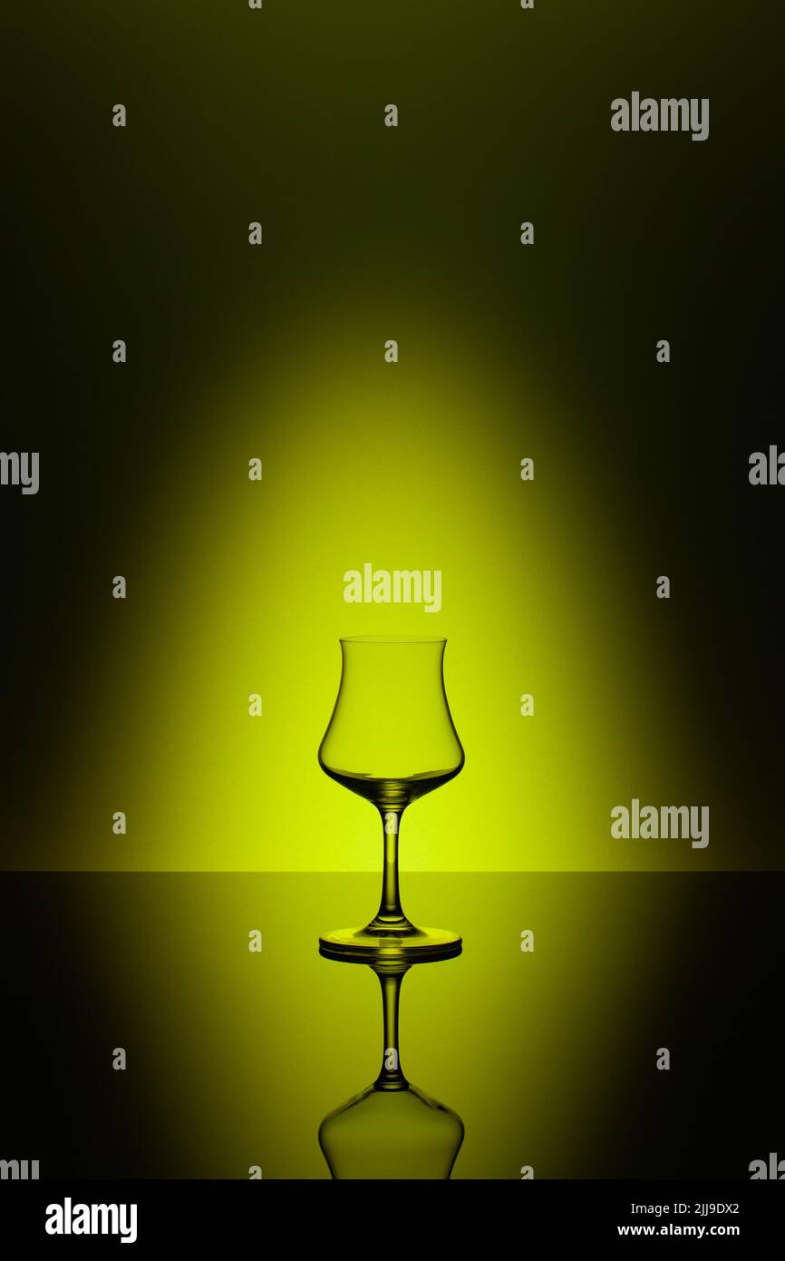 Rum tasting glass on the glass table and yellow background Stock Photo ...