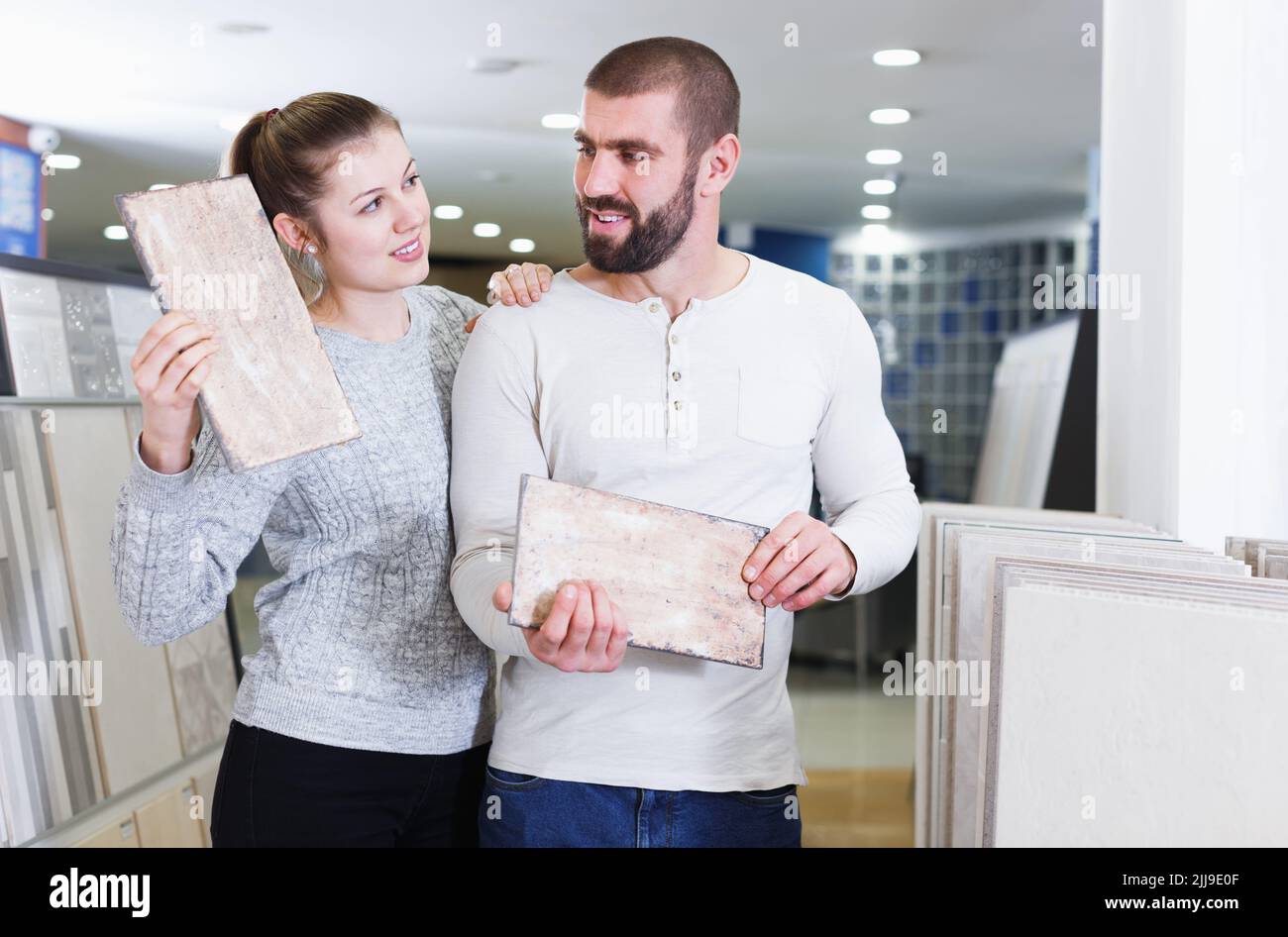 customers with sample of ceramic tile Stock Photo - Alamy
