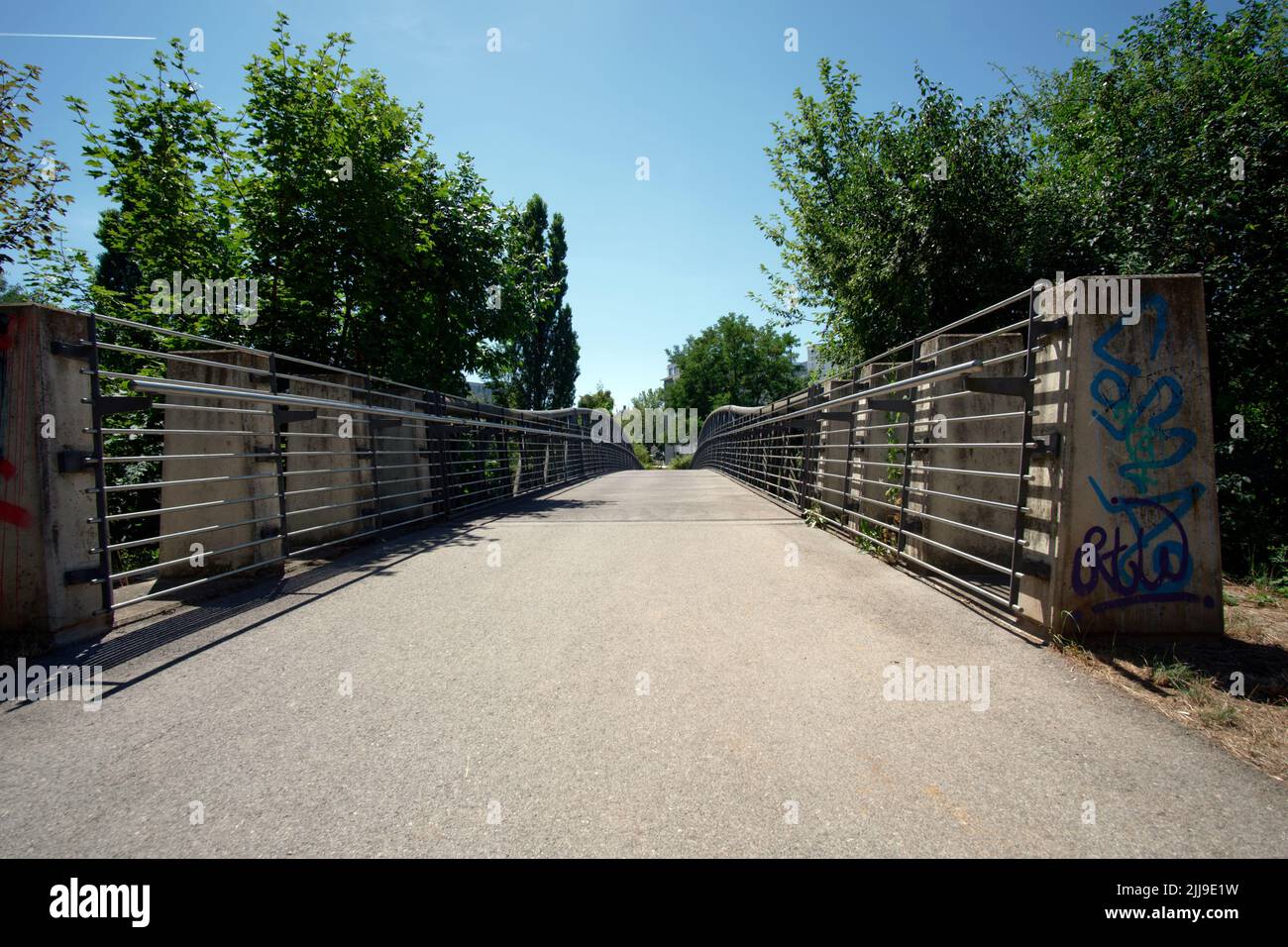 Perspective: view of a pedestrian bridge with steel railing Stock Photo ...