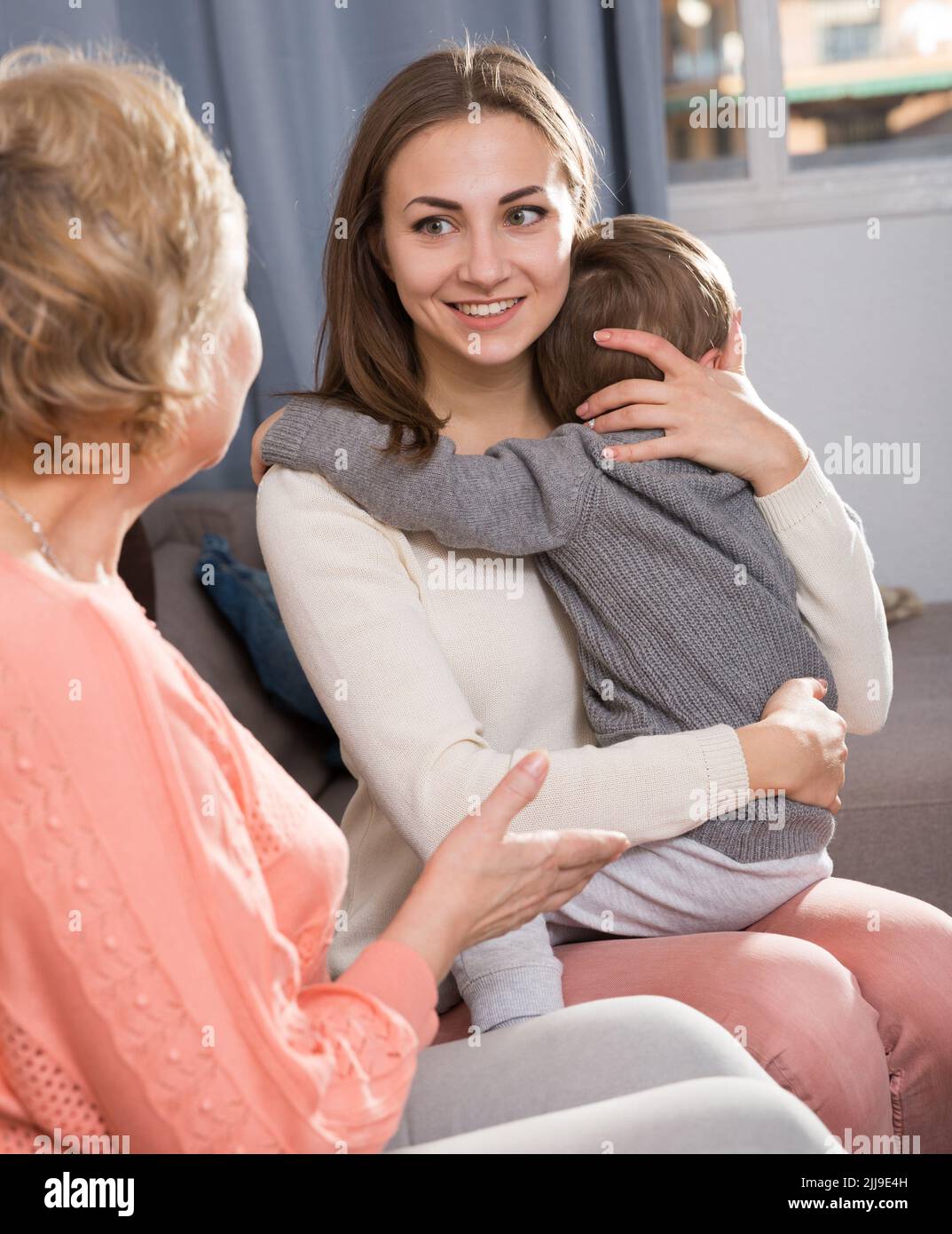 Two adult female are talking about upbringing kid Stock Photo - Alamy