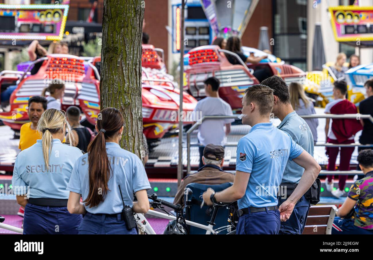 The security standing and smoking together watching over a fair ...