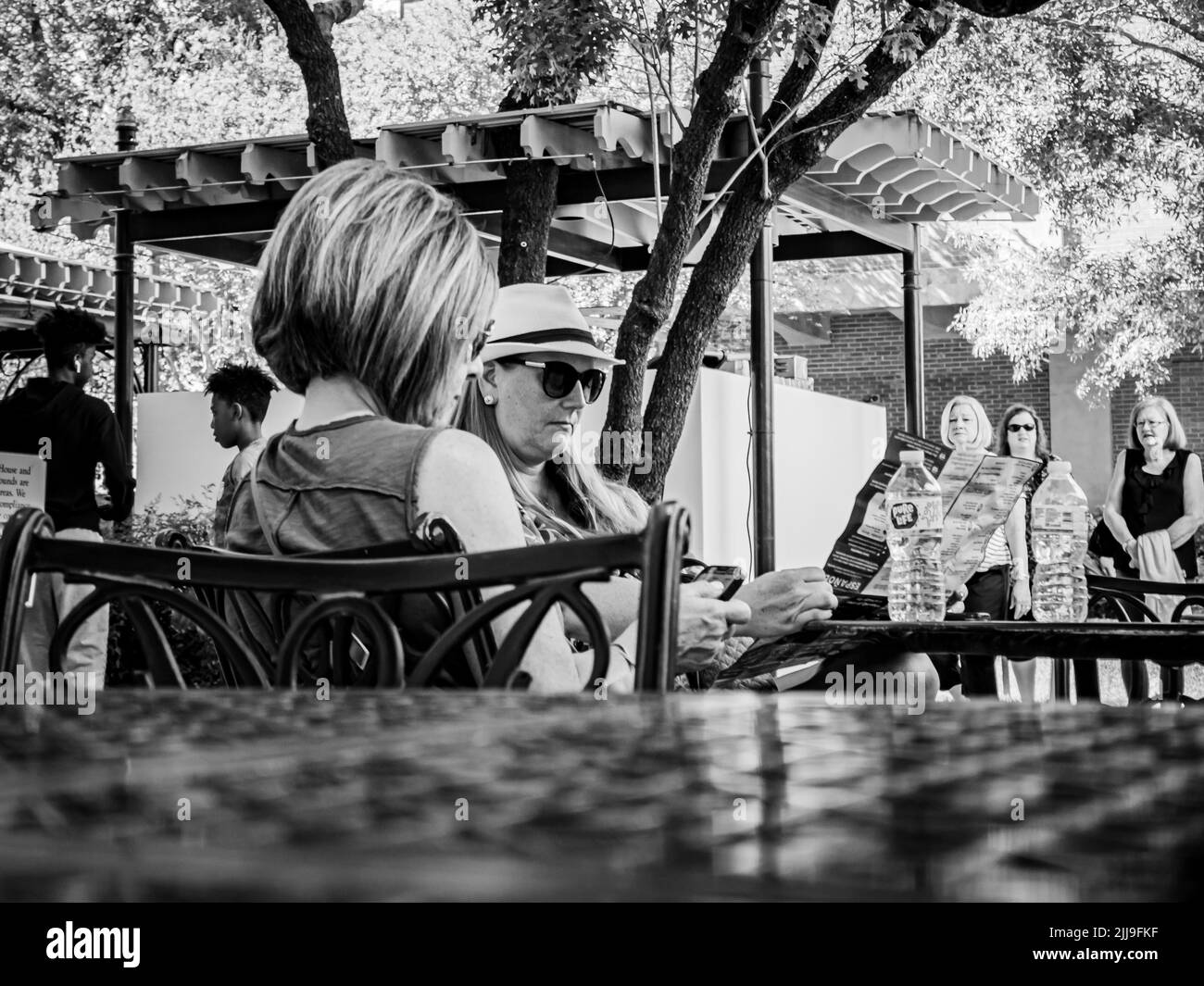 A grayscale of people dining Outside at the Guenther House Stock Photo ...