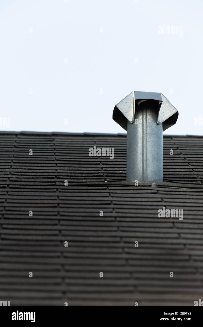 A chimney on a building roof Stock Photo - Alamy