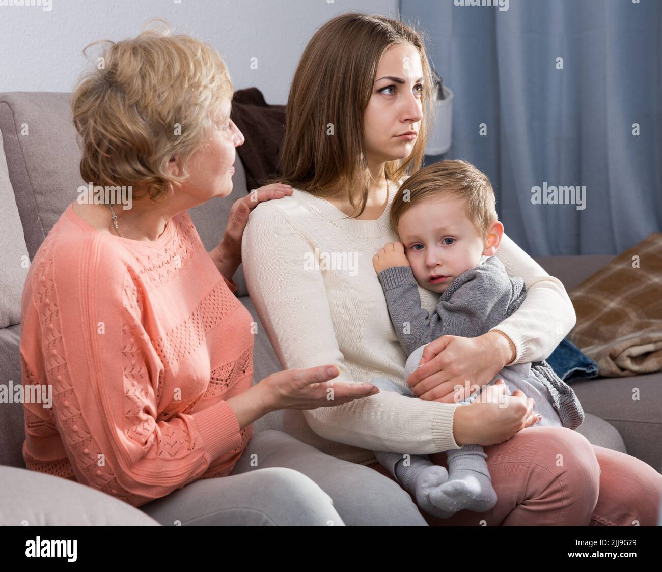 Two adult female are having disagreements with upbringing kid Stock ...