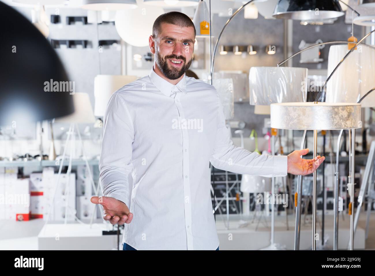 Male standing near lamp in the furniture store Stock Photo - Alamy