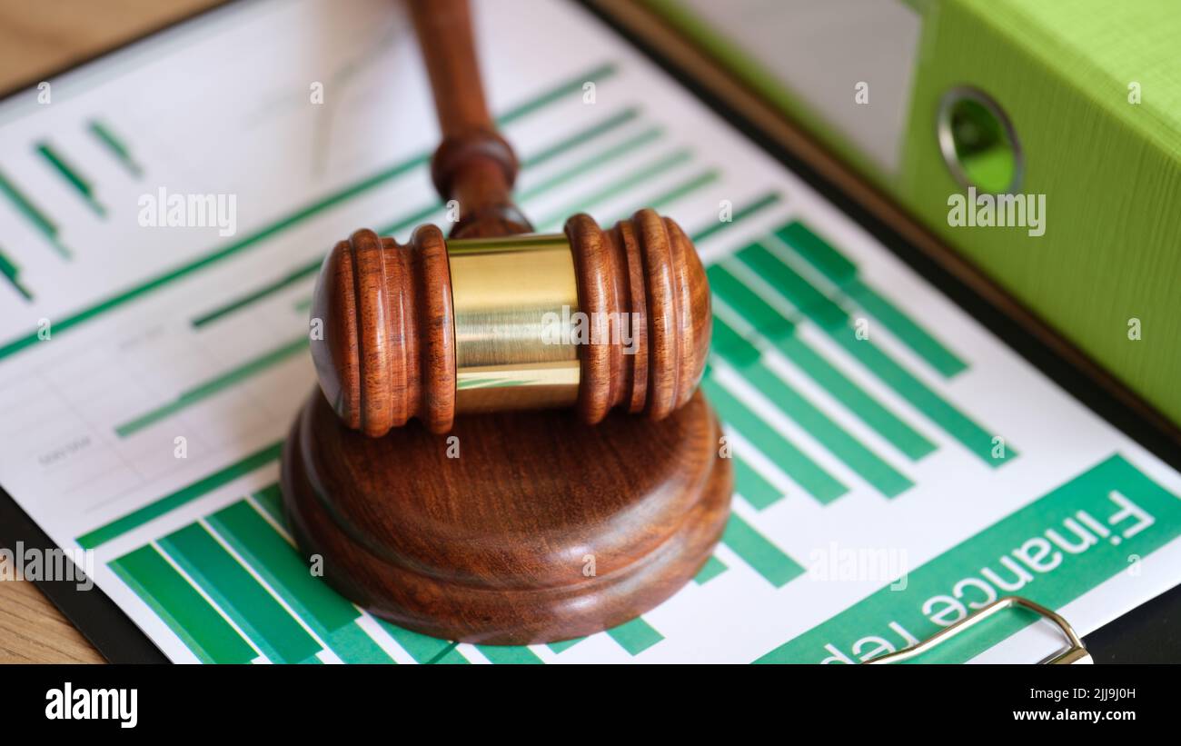 Judge hammer on business financial documents with charts and graphs ...