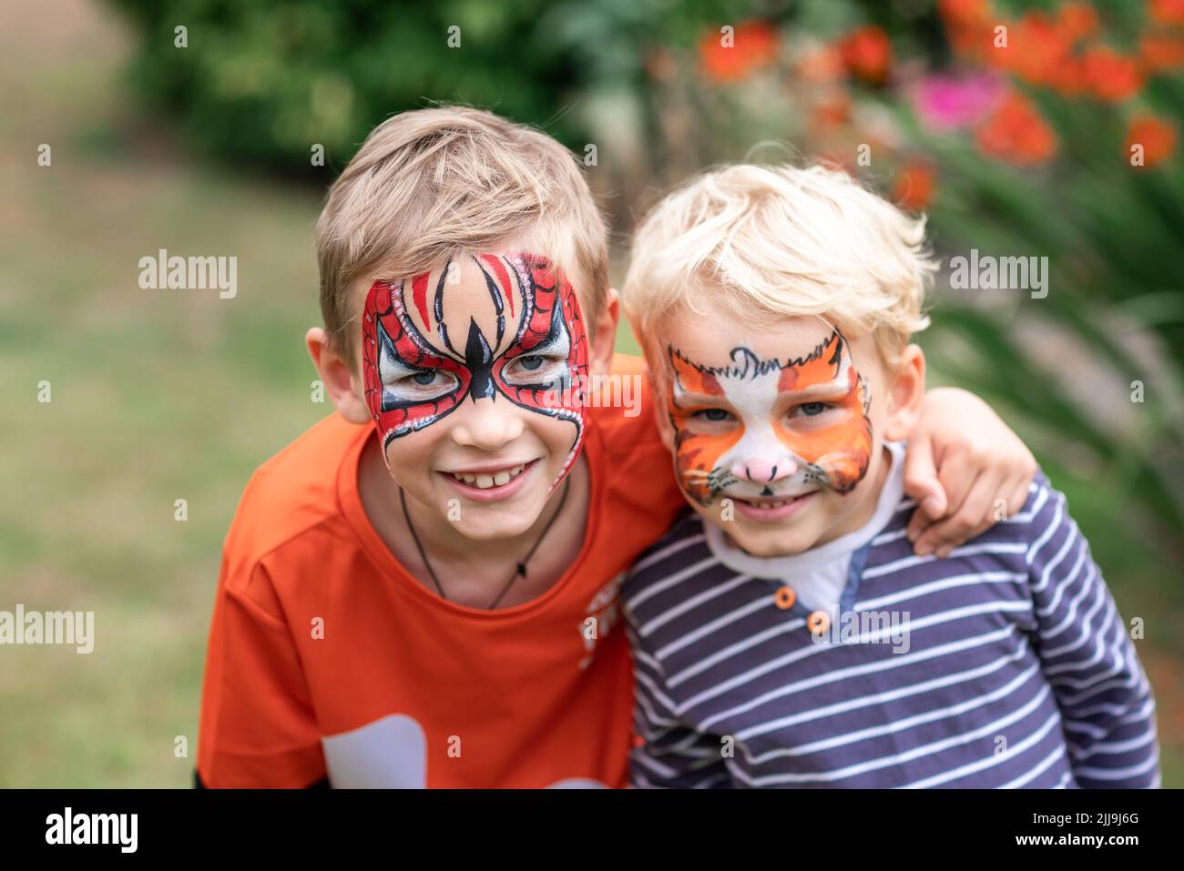 Two happy cute little boys with their faces painted. Face painting ...