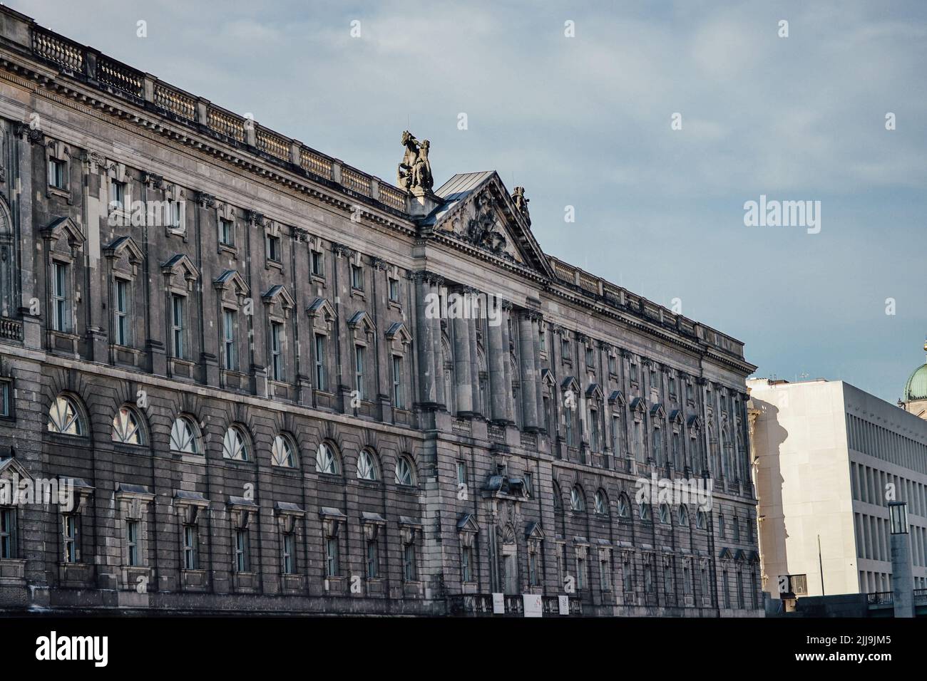 The Marble palace with a balcony and statues on the roof under a cloudy ...