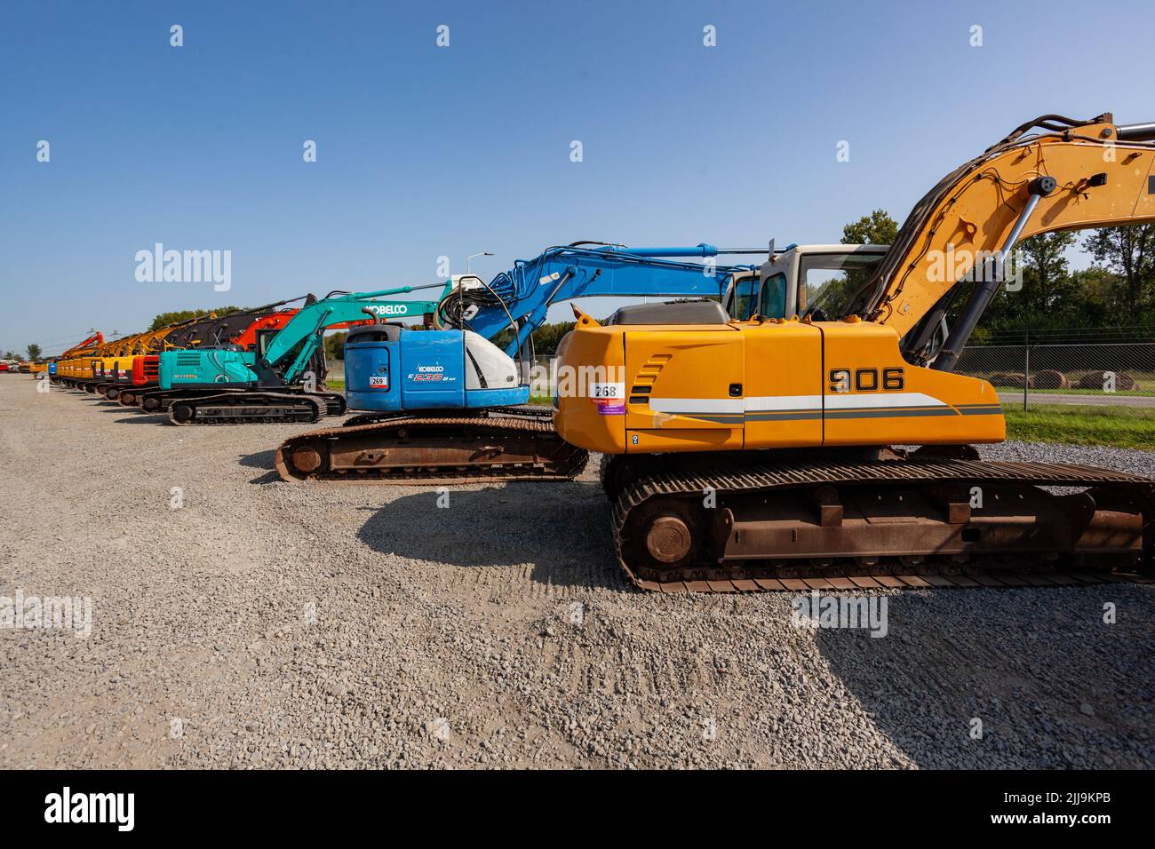 A beautiful view of the row of colorful excavators under the clear sky ...