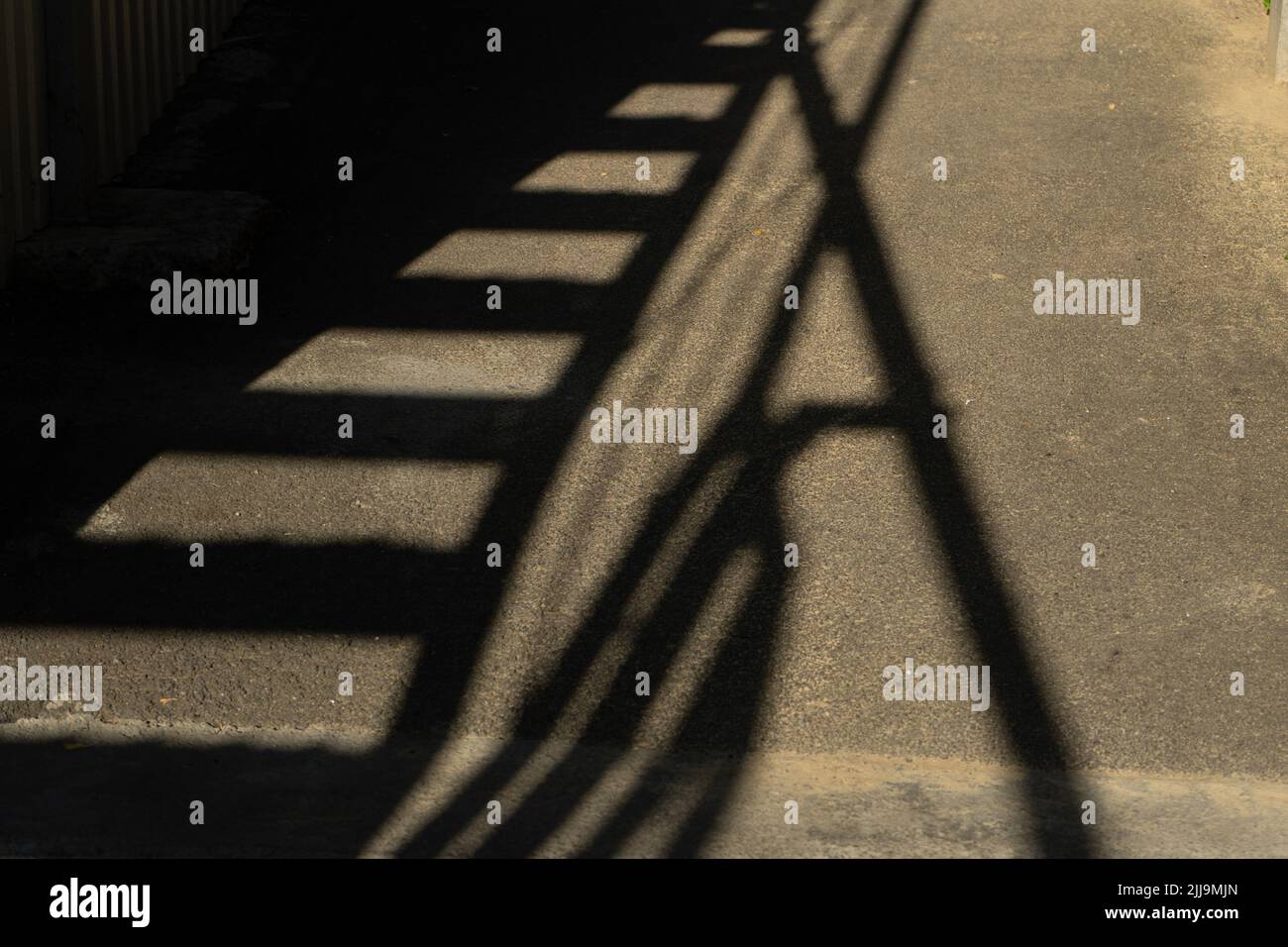 Shadow on the asphalt from an industrial building Stock Photo - Alamy