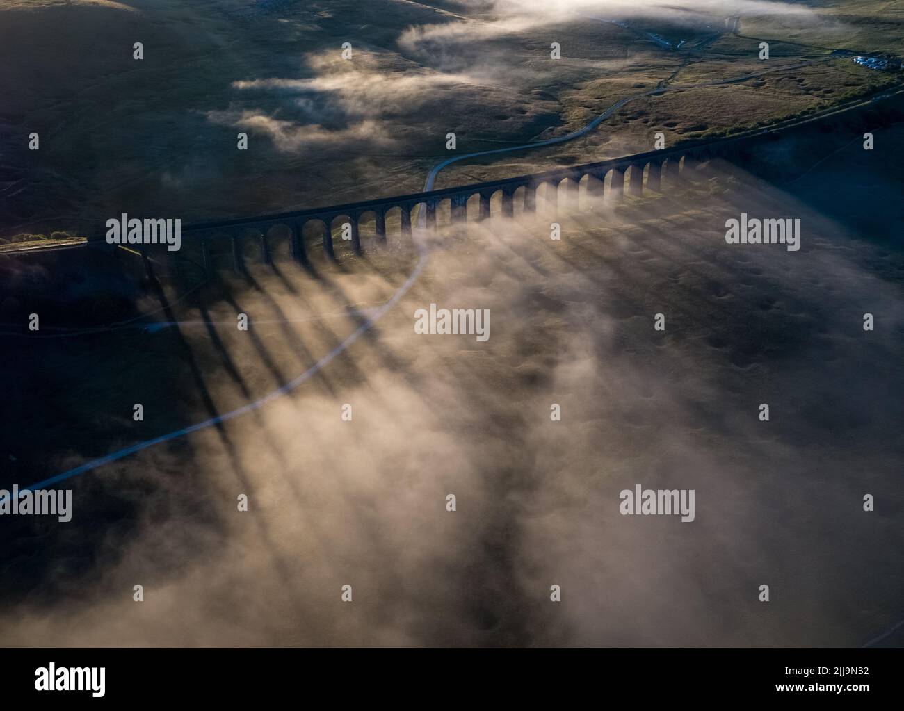 Drone view of the Iconic landmark Ribblehead Viaduct shrouded in early ...