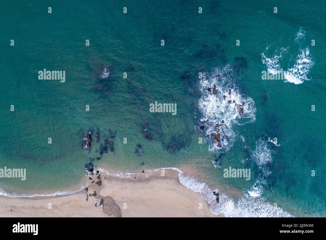 Drone aerial view of a beach with a small watercourse Stock Photo - Alamy