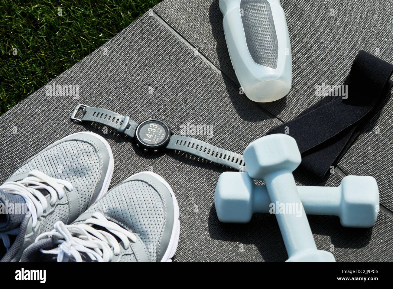 Sport items, fitness smart watches and running sneakers on gray ...