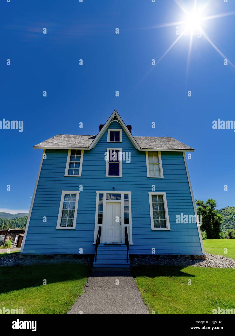 Blue house and sunburst closeup Stock Photo - Alamy