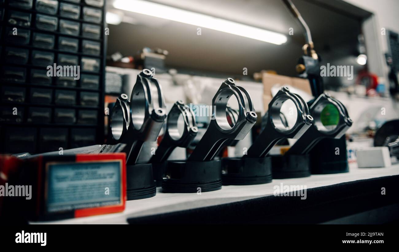 New engine pistons in an old engine shop Stock Photo - Alamy