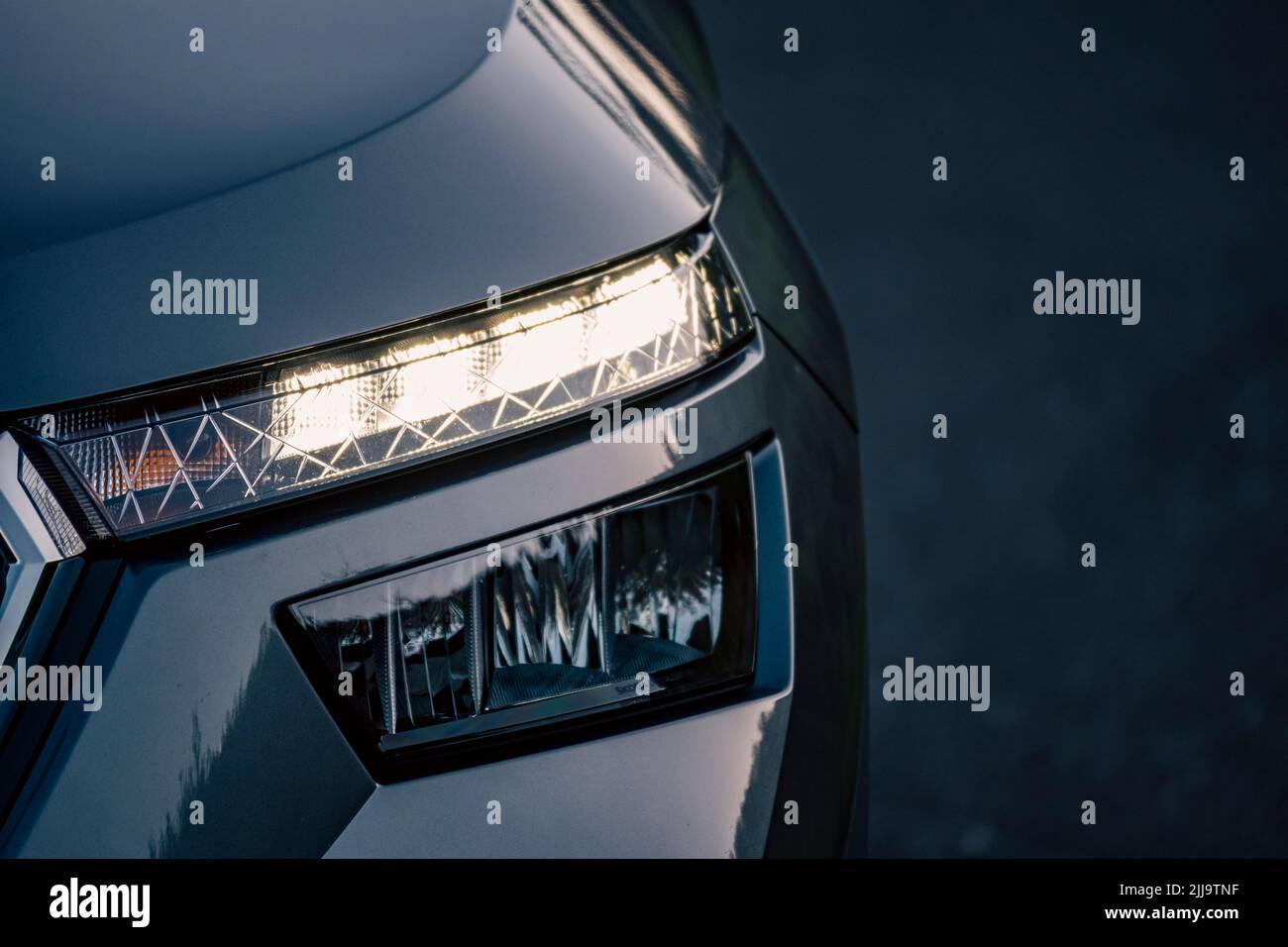 Zagreb, Croatia-July 9th, 2022: Skoda Kamiq car front LED light in the dark behind beautifully ...