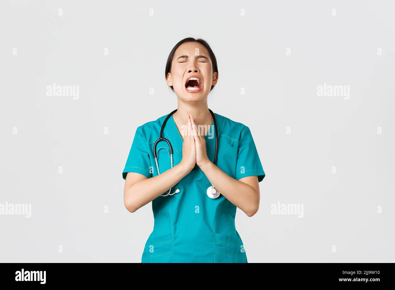 Covid-19, healthcare workers, pandemic concept. Overworked sad and ...