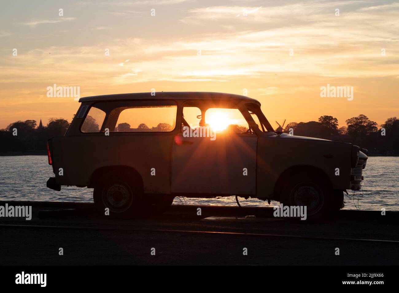A vintage car in a bright sunset sky background. Trip to Copenhagen ...